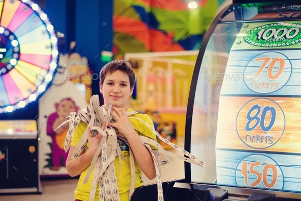 Preteen boy won a jackpot at the slot machine in the amusement park ...