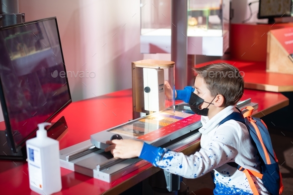 Boy in face mask carting experiment at the Experimentanium kid’s ...