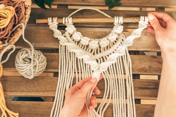 Close up of women's hands weaving macrame in a home workshop,top view ...