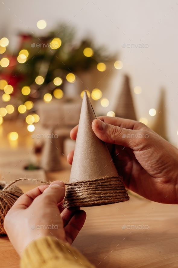 Process of making a Christmas tree out of cardboard and thread, hands ...