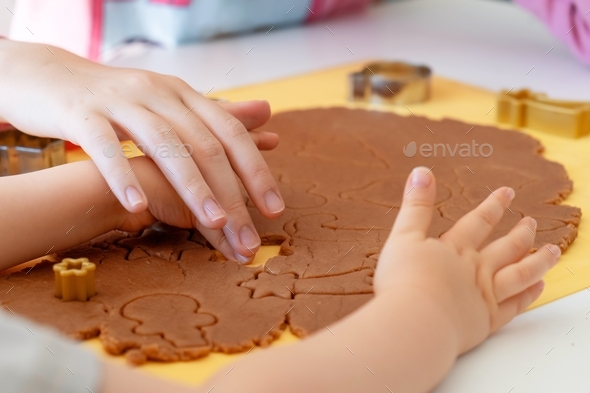 Christmas family fun. Kids making gingerbread cookies at home with ...