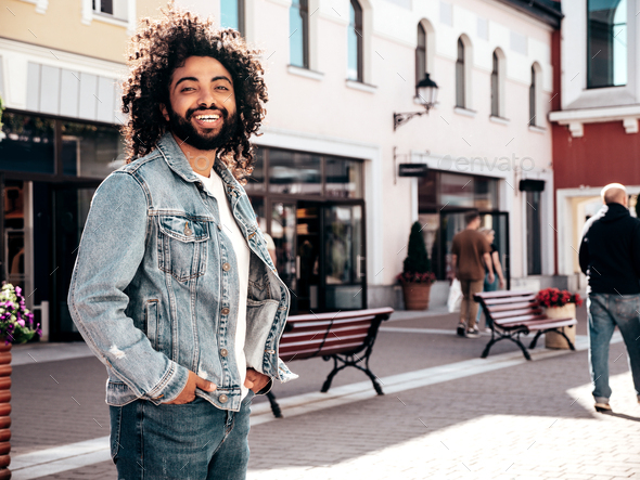 Handsome man posing outdoors at sunny day Stock Photo by halayalex