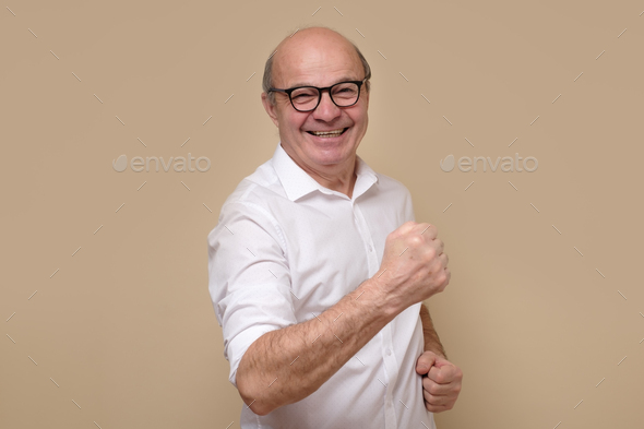 Senior man expressing his excitement and delight by shouting Yes Stock ...