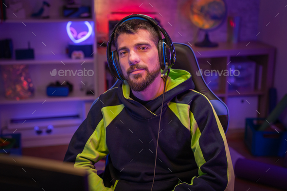 Gamer portrait looking to the camera with Colorful Neon Led Lights ...