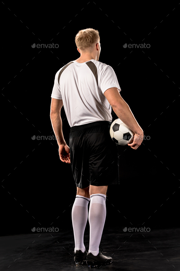 Back side view of soccer player standing and holding soccer ball Stock ...