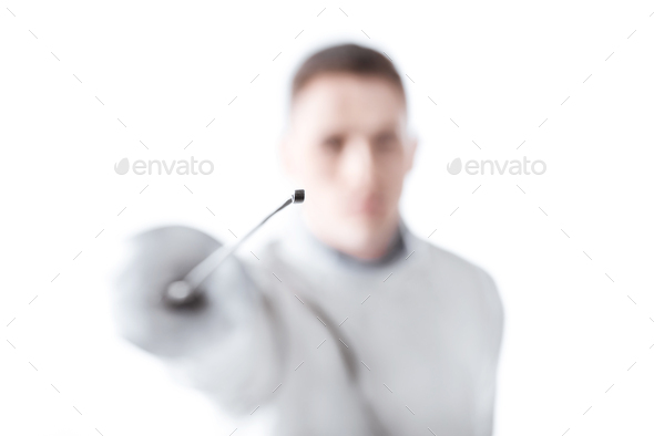 Close-up view of young man professional fencer holding rapier isolated ...