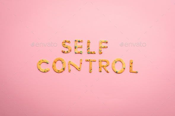 Top view of self control lettering made from sweets isolated on pink ...