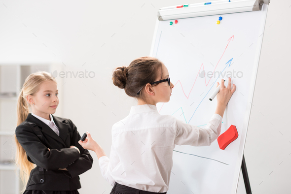 Two little girls in formal clothes making presentation, children in ...
