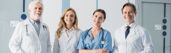Website header of nurse and doctors with stethoscopes looking at camera ...