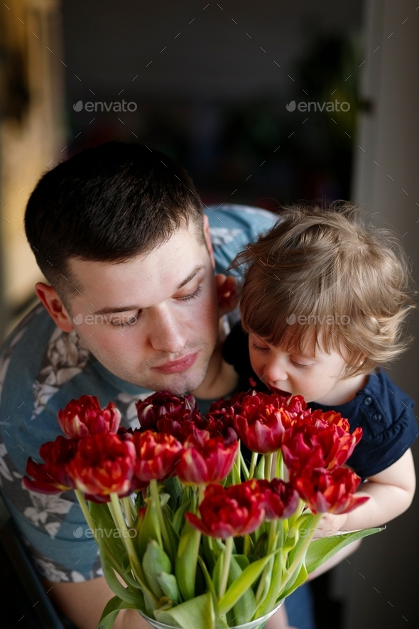 Dad and daughter are sniffing tulips. Girl sniffing flowers Stock Photo ...
