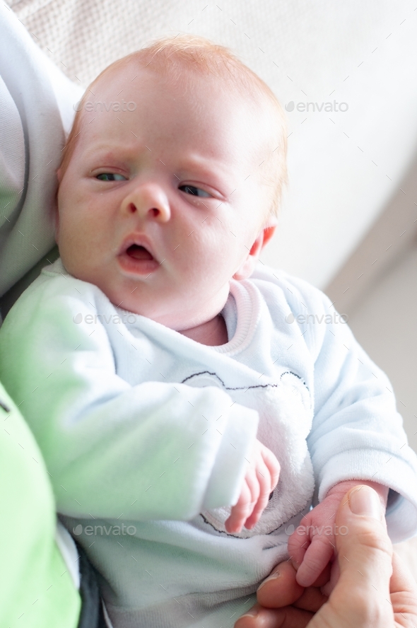 young father rocking his baby with red hair in his arms, cute baby ...