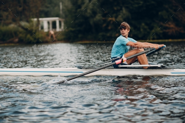 Sportsman single scull man rower rowing at competition boat regatta ...