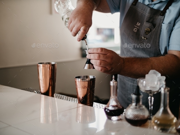 At the bar restaurant drinking bartender serving making cocktails ...