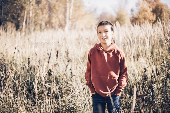 Portrait of teenager boy in field of pampas grass. Slow life in ...