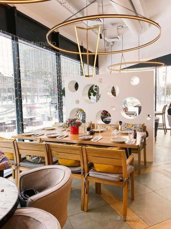 Modern cafe interior with chairs, windows and big chandeliers, interior ...