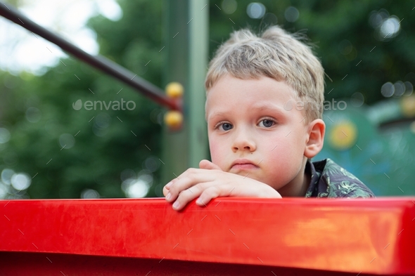 Sad boy looking forward. Closeup portrait. Stock Photo by anastasiabidzilya