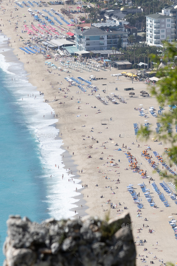 top view of a huge beach where people sunbathe Stock Photo by alexnalivaiko