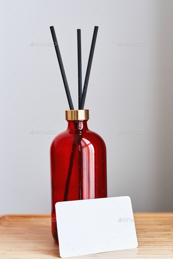 Room fragrance diffuser and plain white paper card on a wooden tray ...