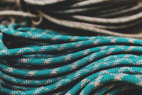 Nylon rope is coiled in a pile at a fishing port. Stack of knotted ...