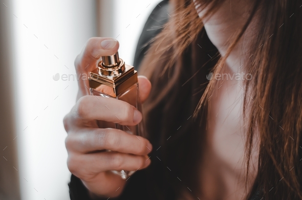 Perfume bottle in woman hands Stock Photo by oleksandrsh | PhotoDune