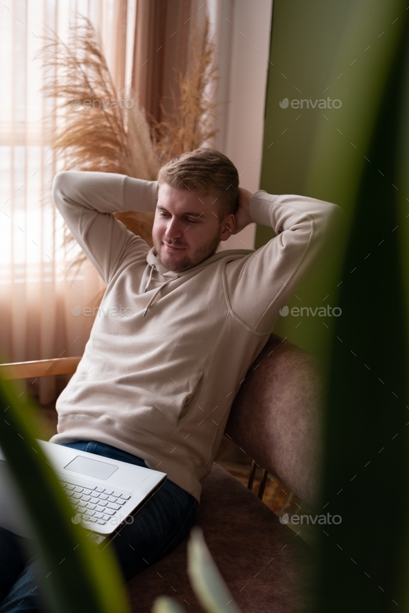 Man relaxing in front of laptop Stock Photo by OlgaSmolina | PhotoDune