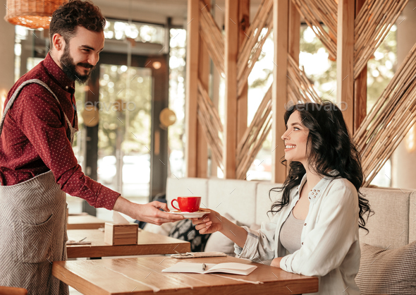 Cheerful waiter giving coffee to client Stock Photo by kegfire | PhotoDune