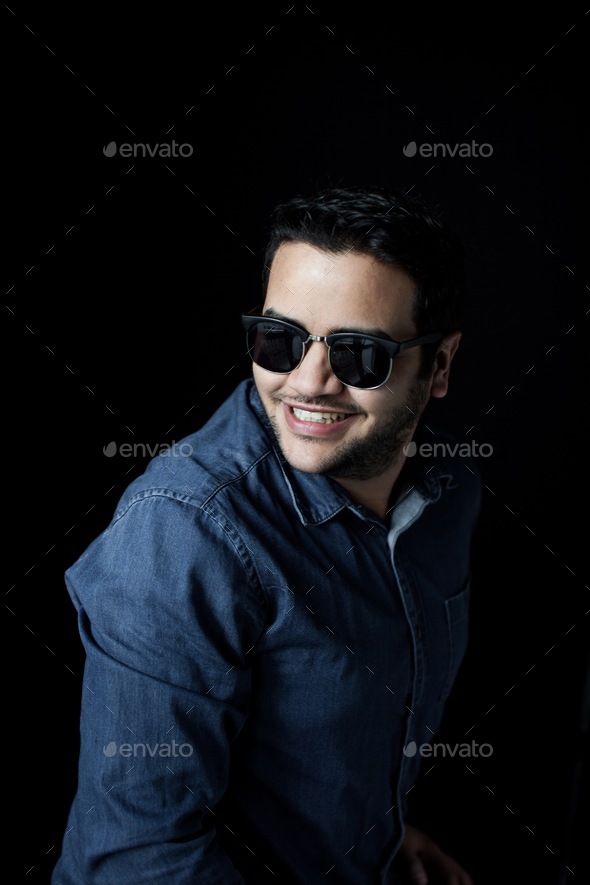 Man Looking back wearing sunglasses and denim shirt looking back with a ...