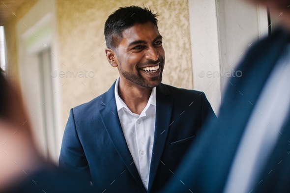Handsome man smiling wearing a suit in a conversation Stock Photo by ...