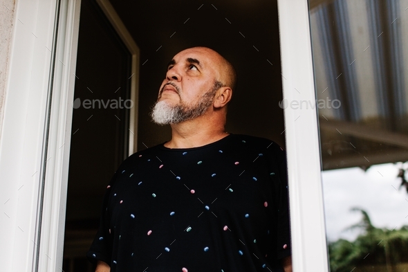 Baby boomer staring at the sky through a window Stock Photo by Lemnaouer