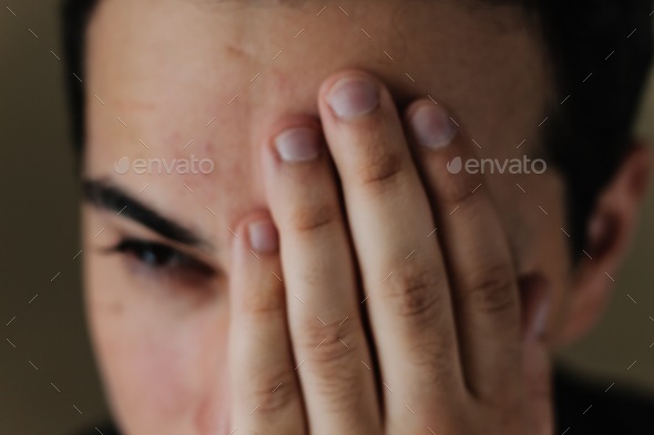 Sad man putting his hand on his face Stock Photo by Lemnaouer | PhotoDune