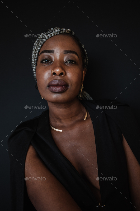 Classy African French woman looking at the camera proudly with braided ...