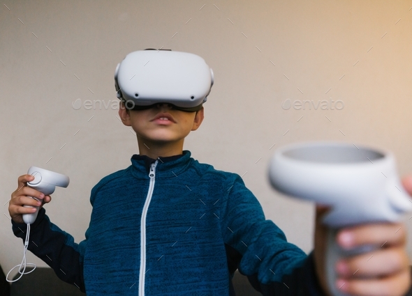 Generation Z boy playing with a VR headset Stock Photo by Lemnaouer