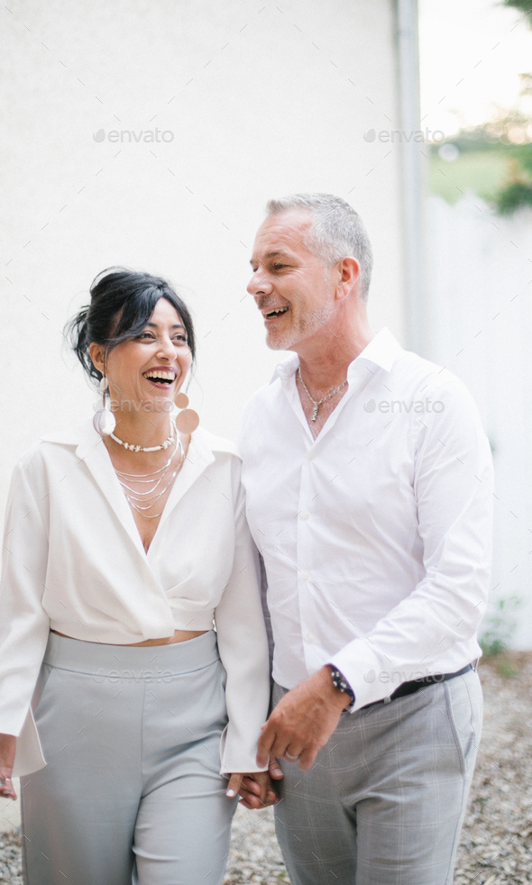 Generation x couple having a laugh together Stock Photo by Lemnaouer