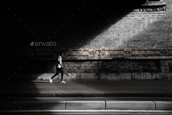 Man walking under a bridge Stock Photo by Lemnaouer | PhotoDune