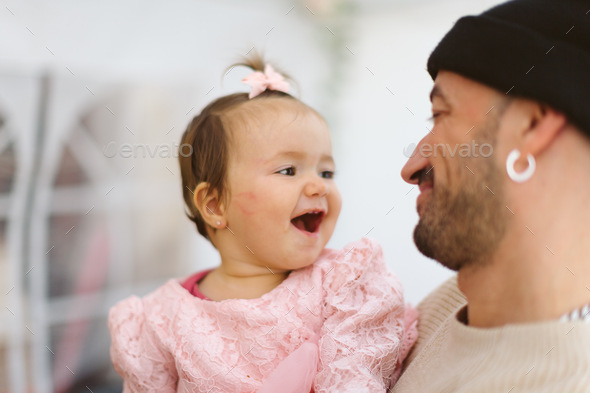 Cute baby girl smiling with her uncle Stock Photo by Lemnaouer | PhotoDune