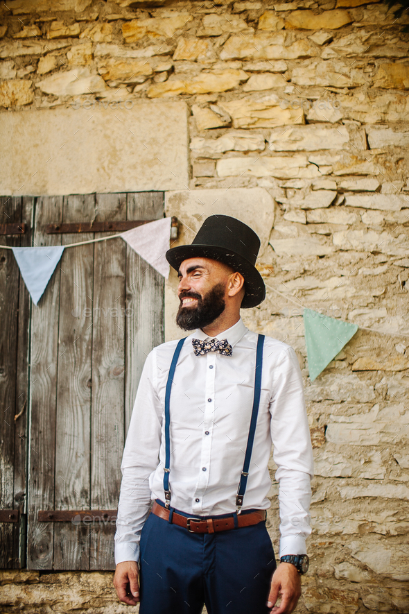 Bearded Man wearing a hat, bow tie, white shirt and suspenders Stock ...