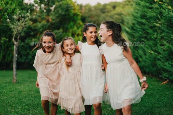 Four girls walking together and laughing Stock Photo by Lemnaouer