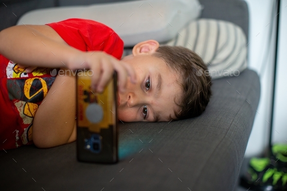 Closeup on an Autistic kid using a mobile phone to watch videos Stock ...