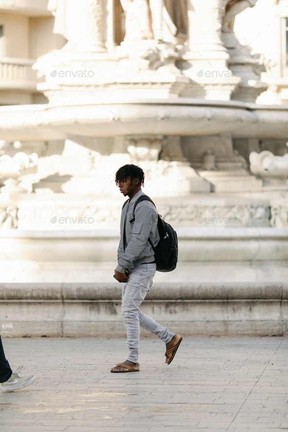 Young Black man walking outside Stock Photo by Lemnaouer | PhotoDune
