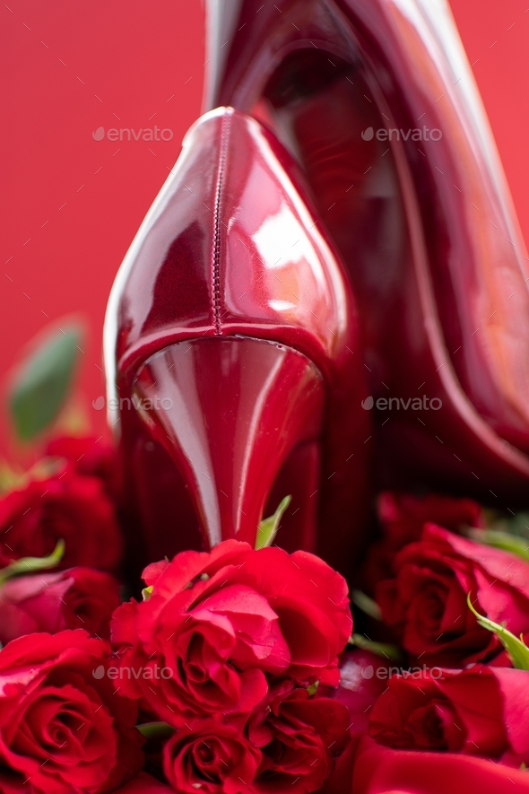 Red high heel shoes with roses on satin background Stock Photo by mary_8405