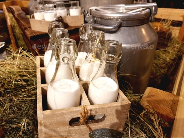 Farm products. Dairy products in the box. Milk and sour cream in glass ...