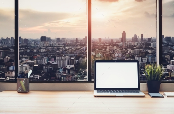 Laptop on table in office room on window city background, for graphics ...