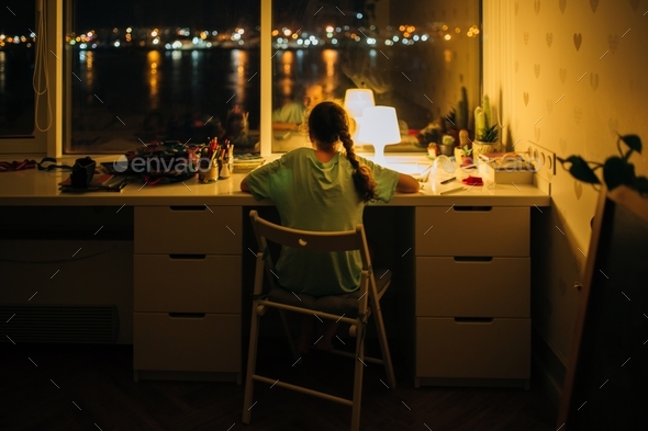 Young girl school student is studying late at night in her room Stock ...