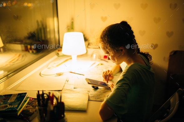 Young girl school student is studying late at night in her room Stock ...