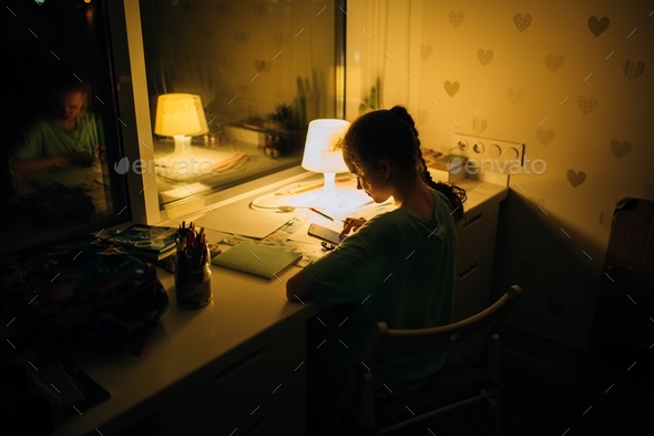Young girl school student is studying late at night in her room Stock ...