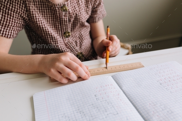 Happy girl sitting at the table and studying. Homeschool. Kid doing ...