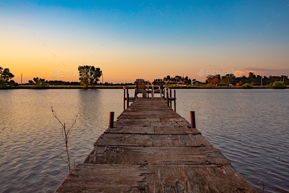 Old wooden dock on a small lake at sunset Stock Photo by foremankelly