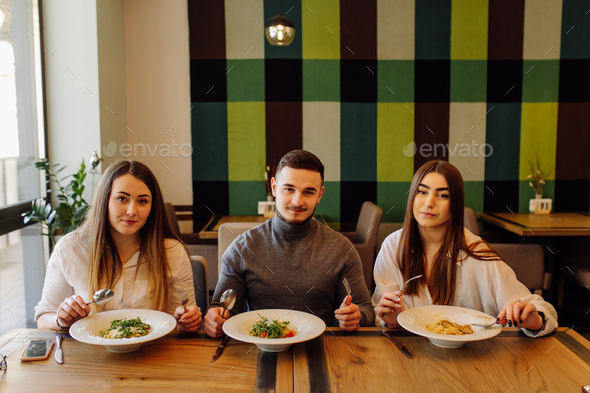 Friends enjoying lunch in the restaurant, eating paste Stock Photo by ...