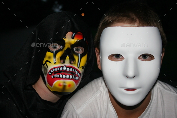 Two brothers showing their Halloween masks up close Stock Photo by ...