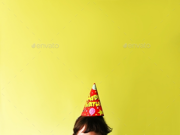 Happy birthday cap on head on bright festive background/ surprise ...